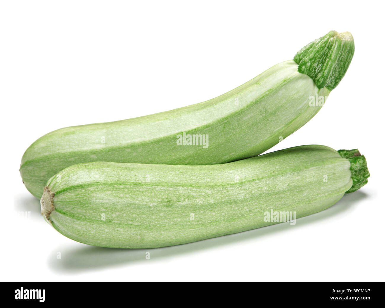 Green zucchini vegetable with shadow on white Stock Photo - Alamy