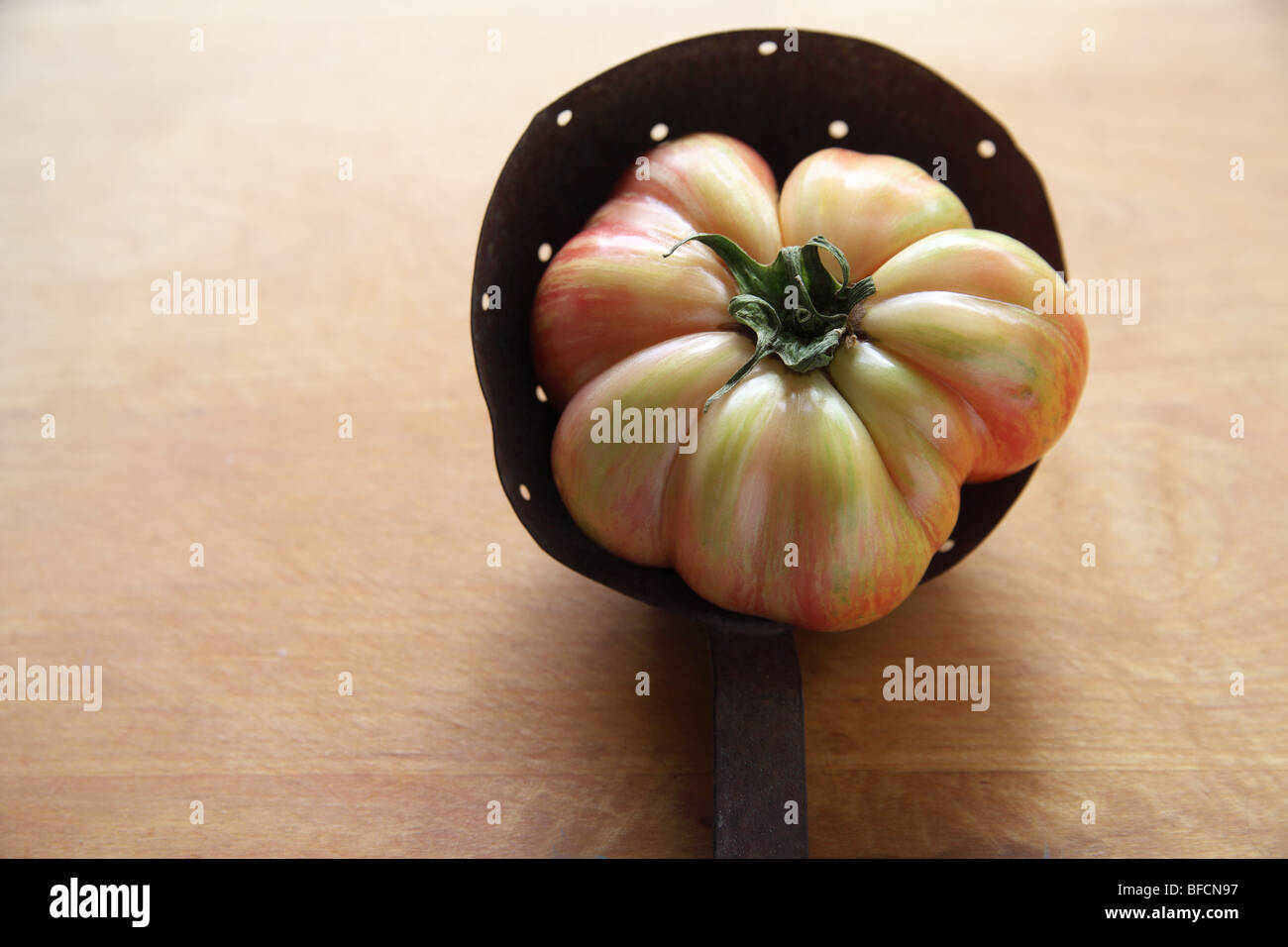 heirloom tomato on an antique ladle Stock Photo - Alamy