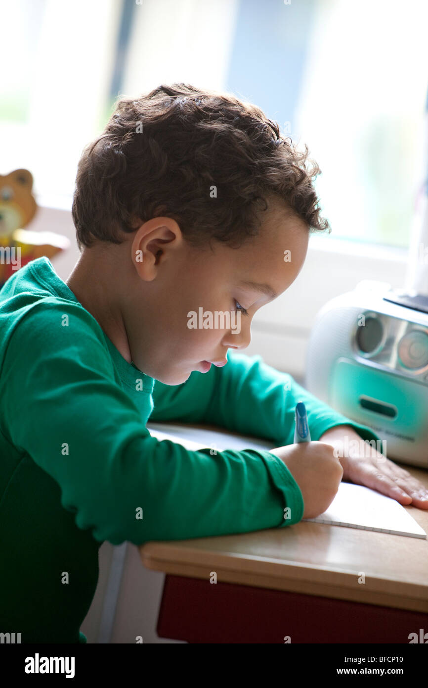 Seven year old boy is writing Stock Photo - Alamy