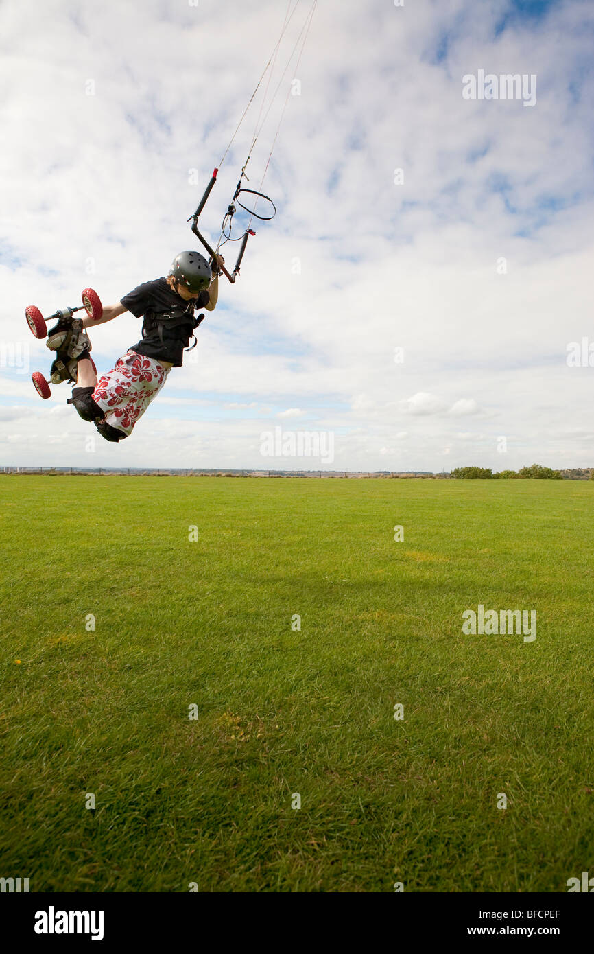 Extreme sport, freestyle kite landboarding, flying inland in open field ...