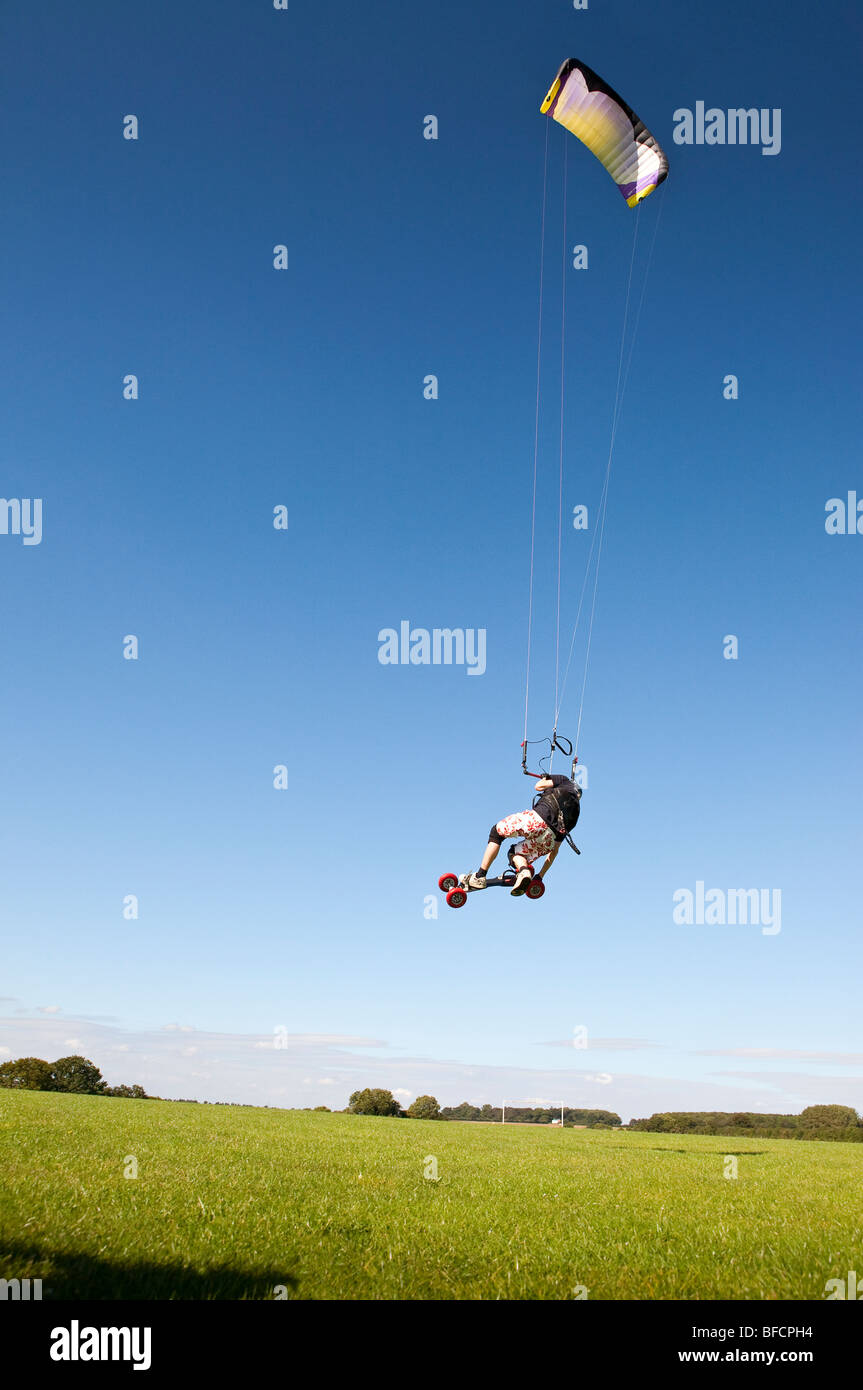 Extreme sport, freestyle kite landboarding, flying inland in open field ...