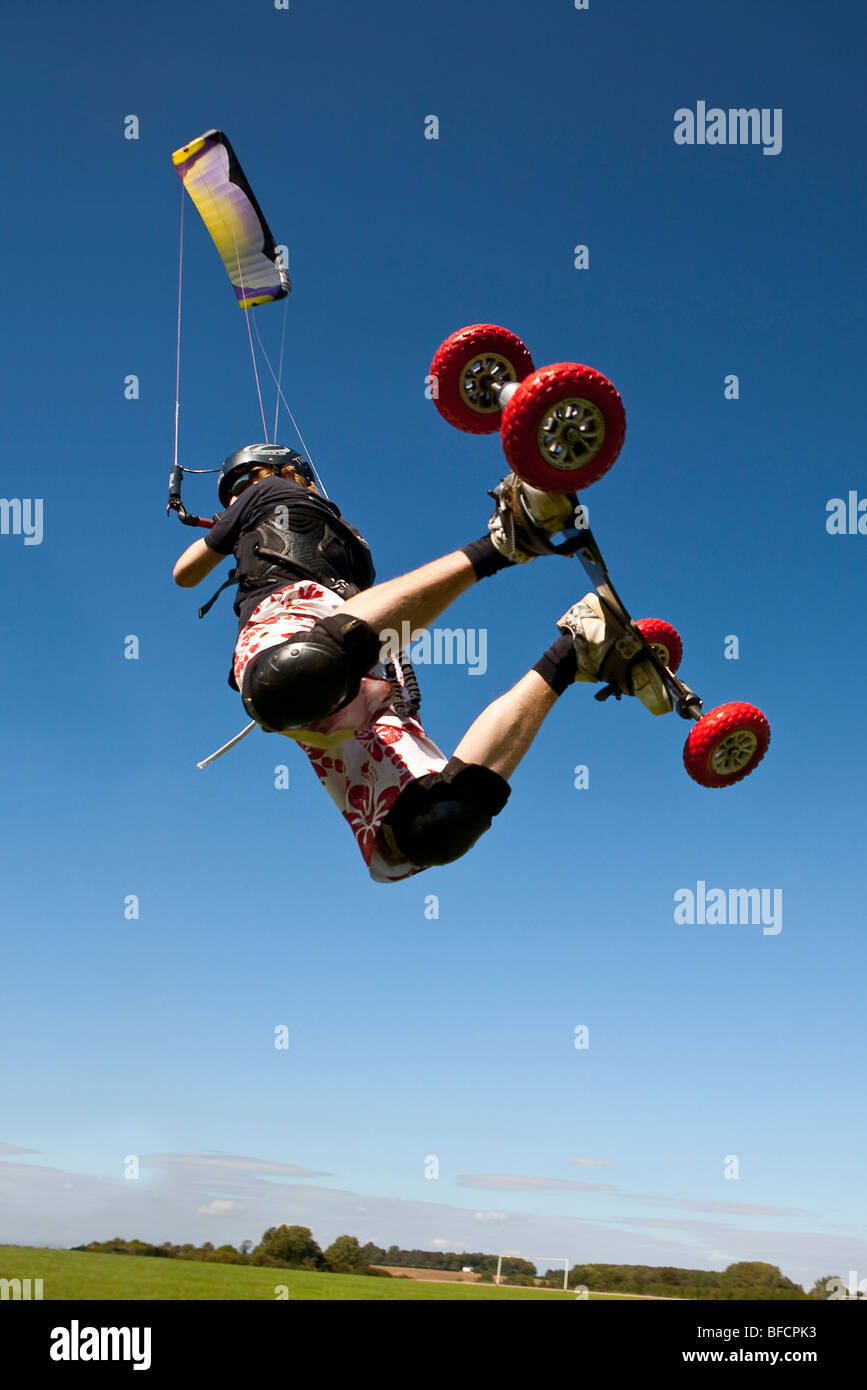 Extreme sport, freestyle kite landboarding, flying inland in open field ...