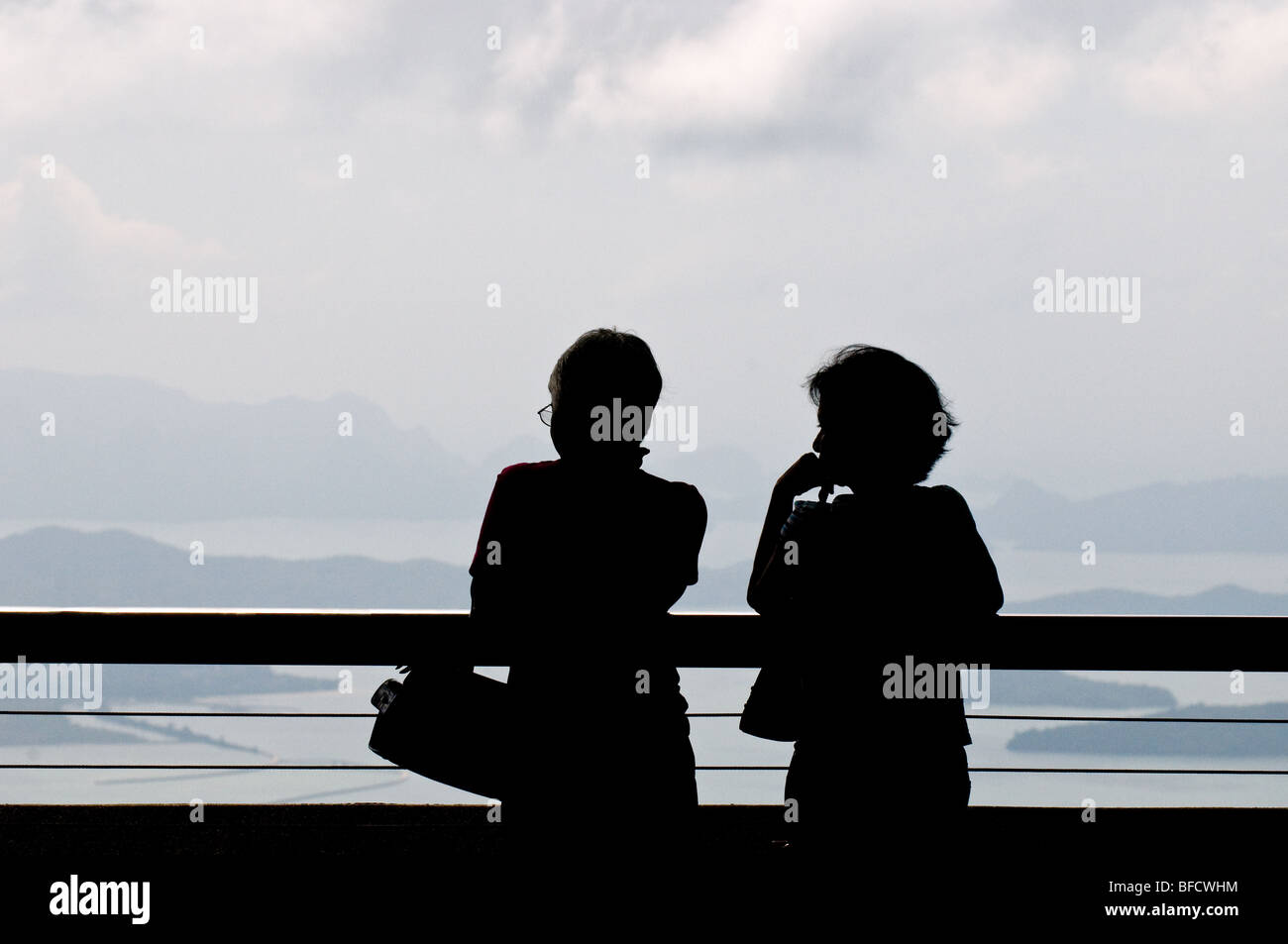 Tourists on top of Gunung Mat Chinchang looking out at the coastline of ...