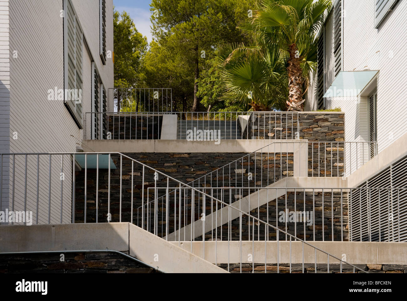 Modern geometric concrete staircase between apartment buildings leading ...