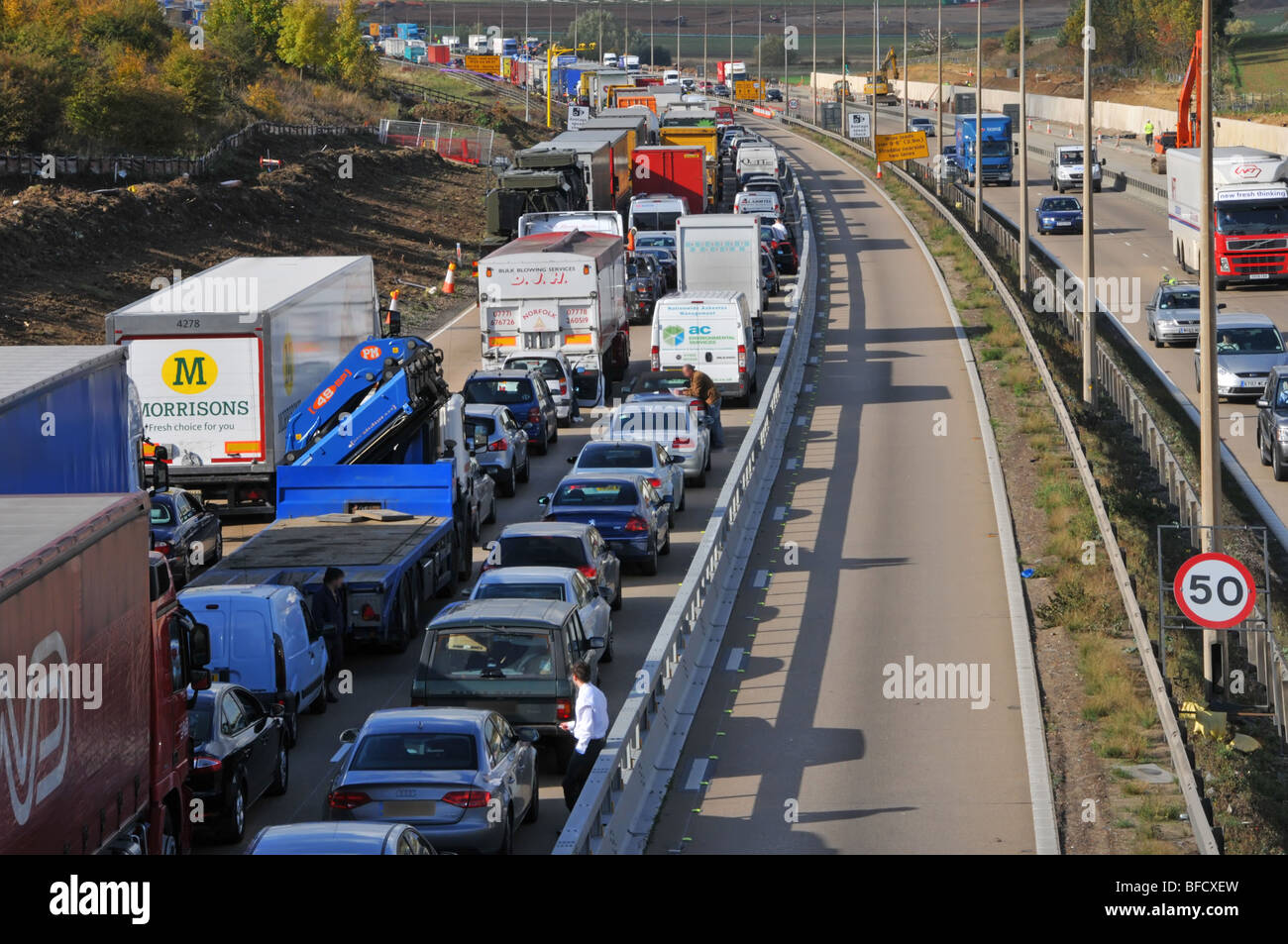 Motorists out of vehicles gridlocked traffic M25 motorway roadworks ...