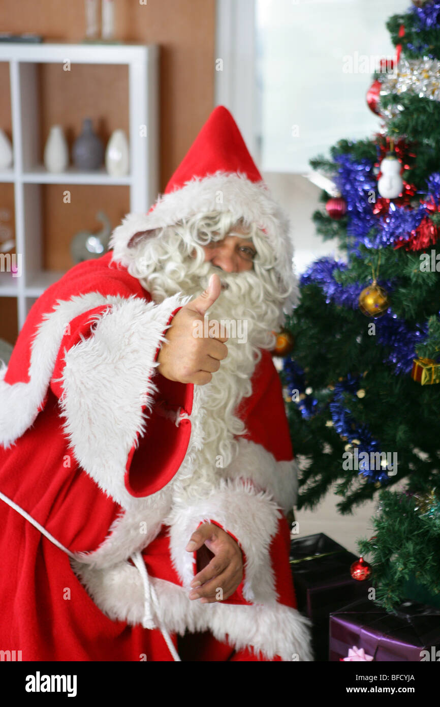 father Christmas beside tree Stock Photo - Alamy