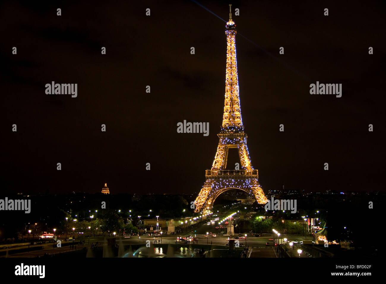 The Eiffel Tower lit up at night located on the Champ de Mars in Paris ...
