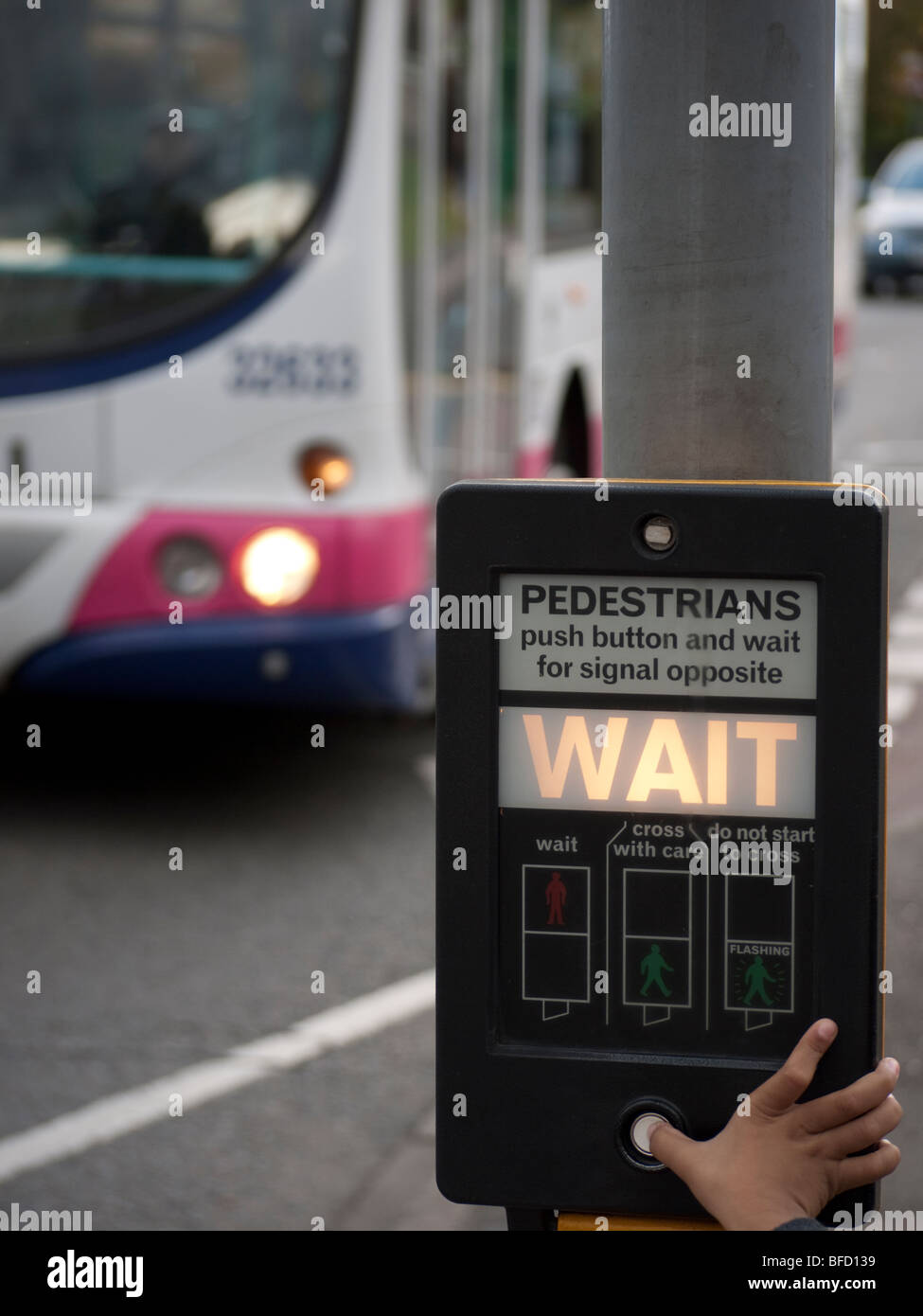 Child pressing the wait button at pedestrian crossing Stock Photo - Alamy