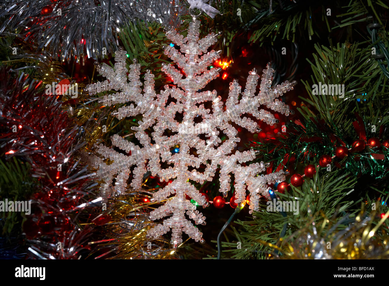 snowflake decoration hanging on an artificial christmas tree Stock ...