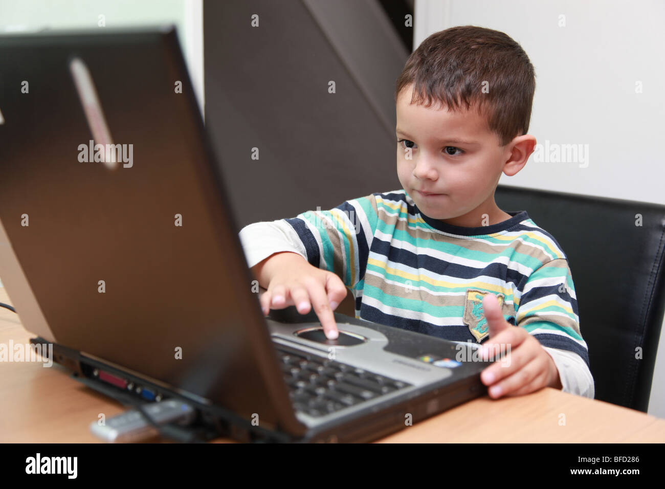 Young boy using a laptop Stock Photo - Alamy