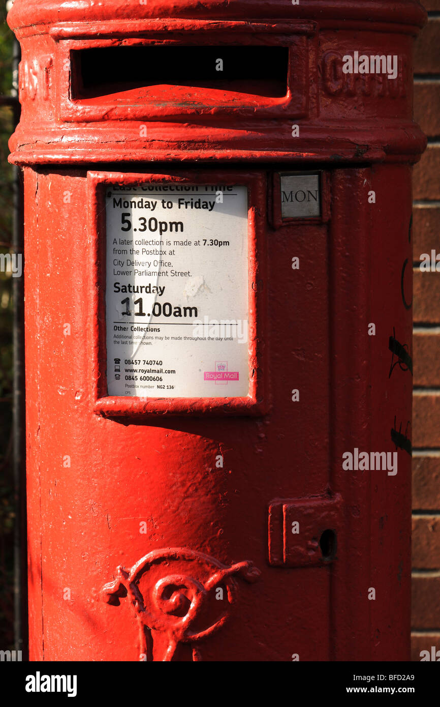 Damaged sign notice on a red Royal Mail pillar box post box showing ...