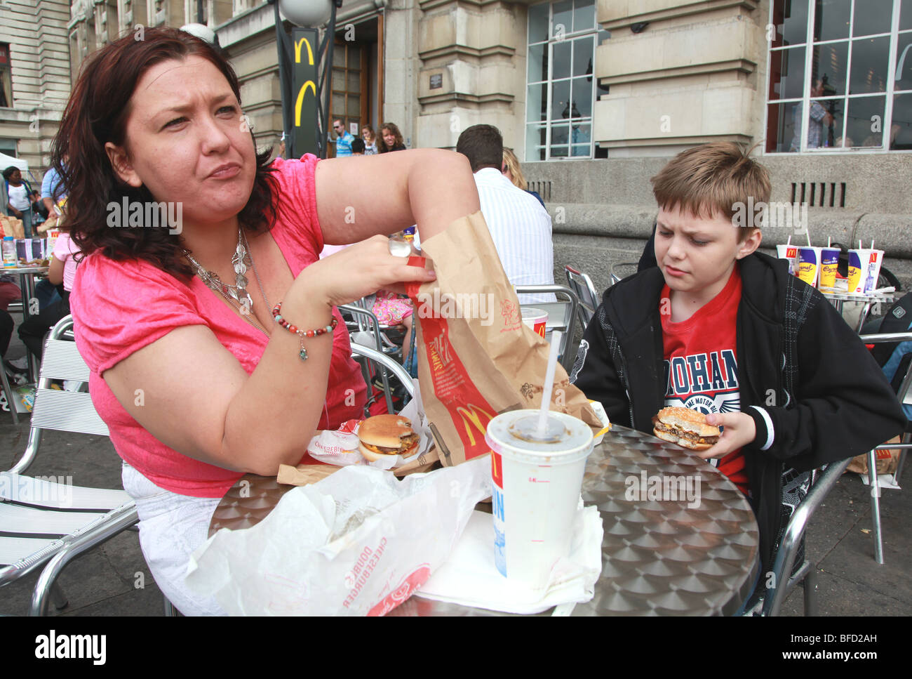 Mother and son eating fast food at outside cafe Stock Photo - Alamy