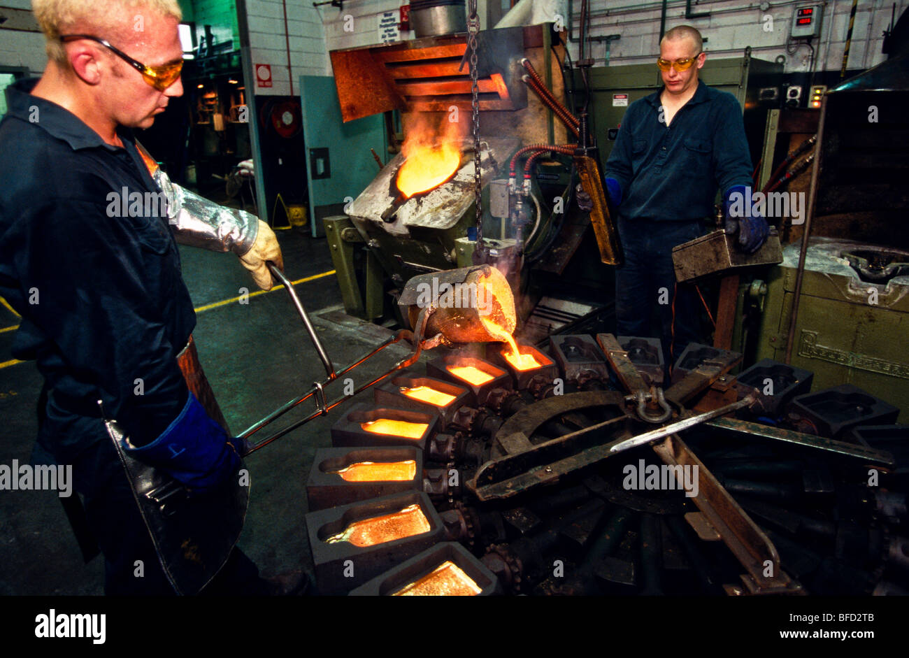 Pouring 99.3% pure gold into anode molds for final purifying, Western ...