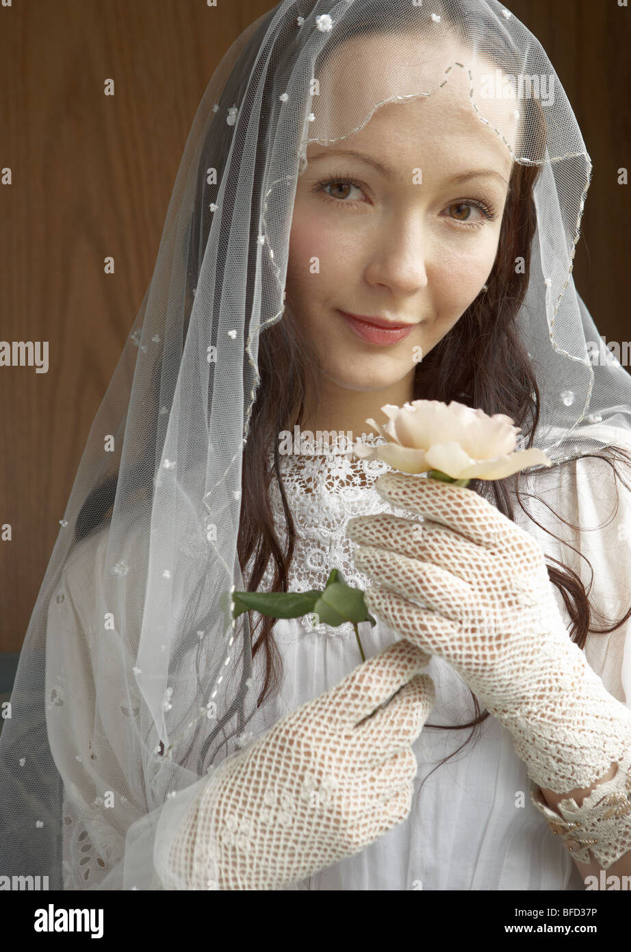 Bride holding rose Stock Photo - Alamy