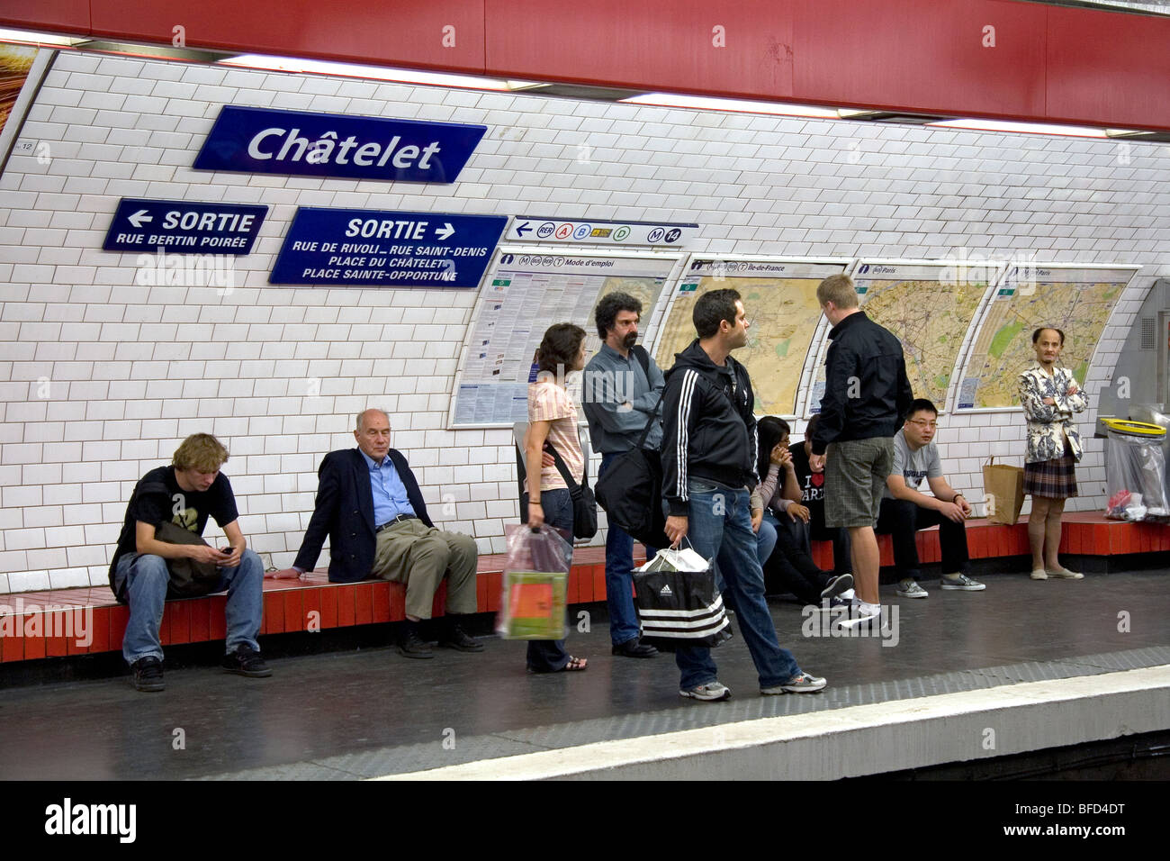 People wait underground on the platform of Chatelet Paris Metro station ...
