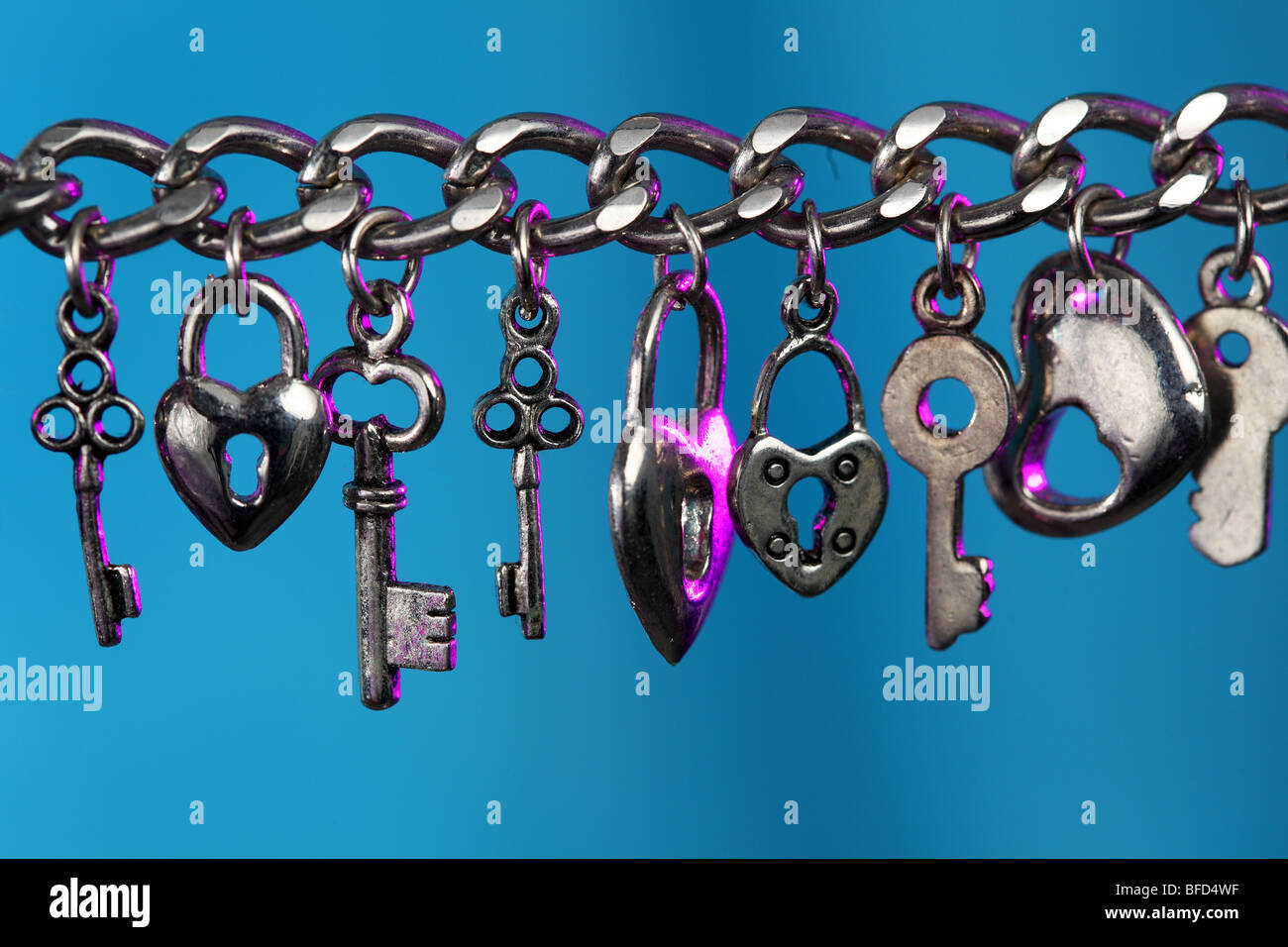 metal chain key keys lock hart blue background purple reflection close ...