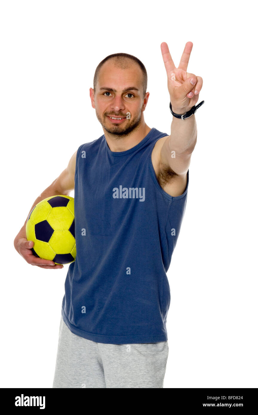 Man holding a soccer ball and making peace sign Stock Photo - Alamy