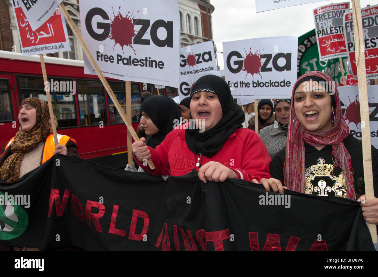 South London March for Palestine. YOung Muslim women hold banner and ...