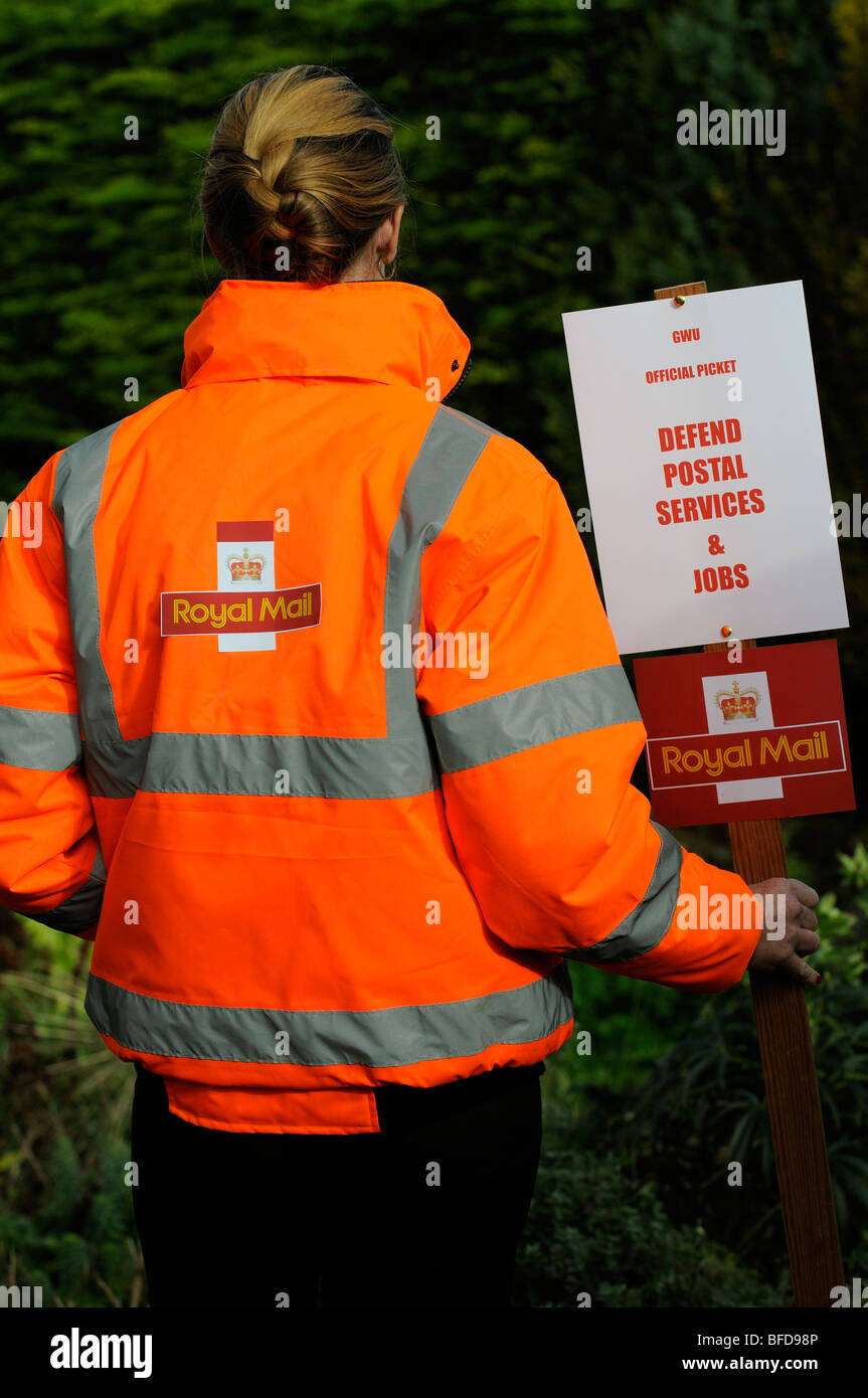 Rear view portrait of a female Royal Mail postal worker on picket duty ...