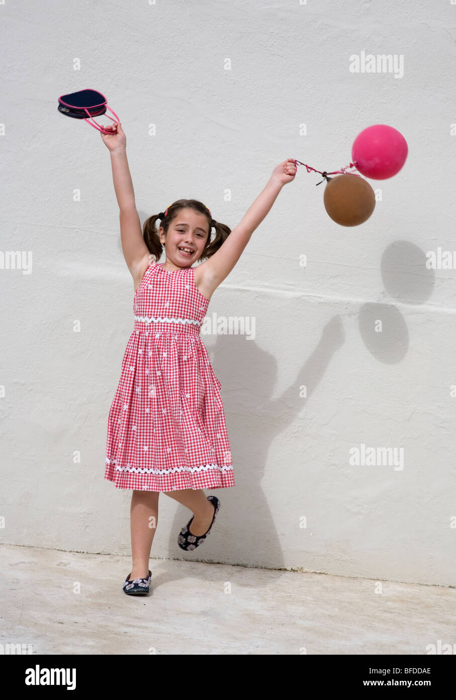 Party girl with balloons jumping up and down and moving Stock Photo - Alamy