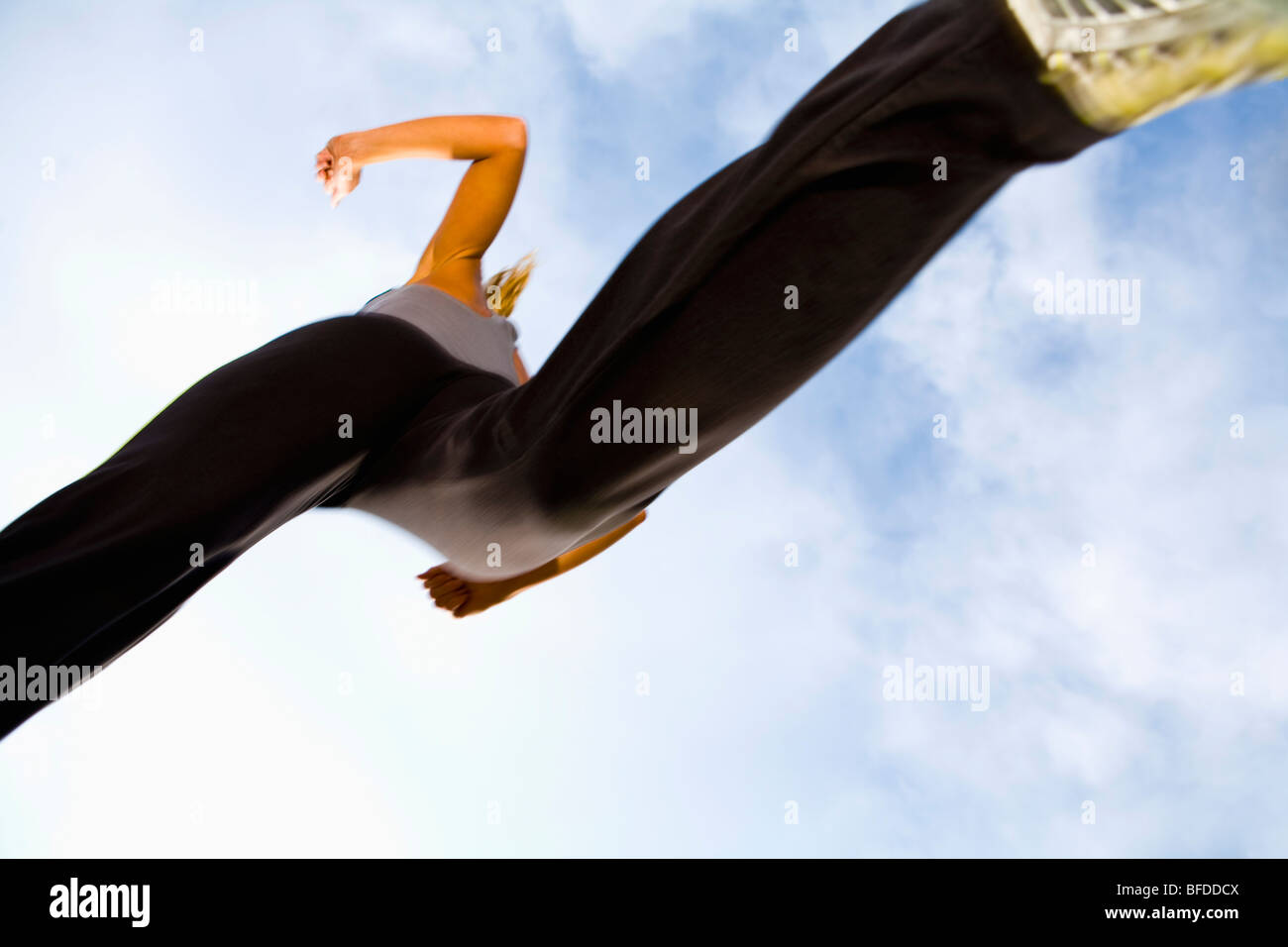 A low angle shot of a woman out for a run in Malibu, California Stock ...