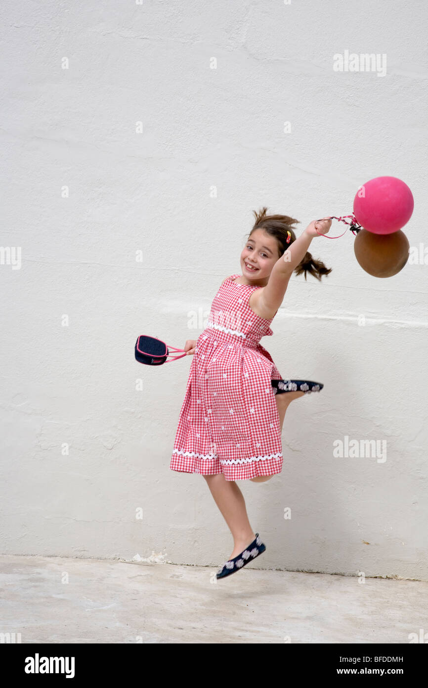 Party girl with balloons jumping up and down and moving Stock Photo - Alamy