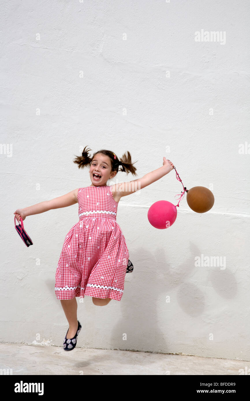 Party girl with balloons jumping up and down and moving Stock Photo - Alamy