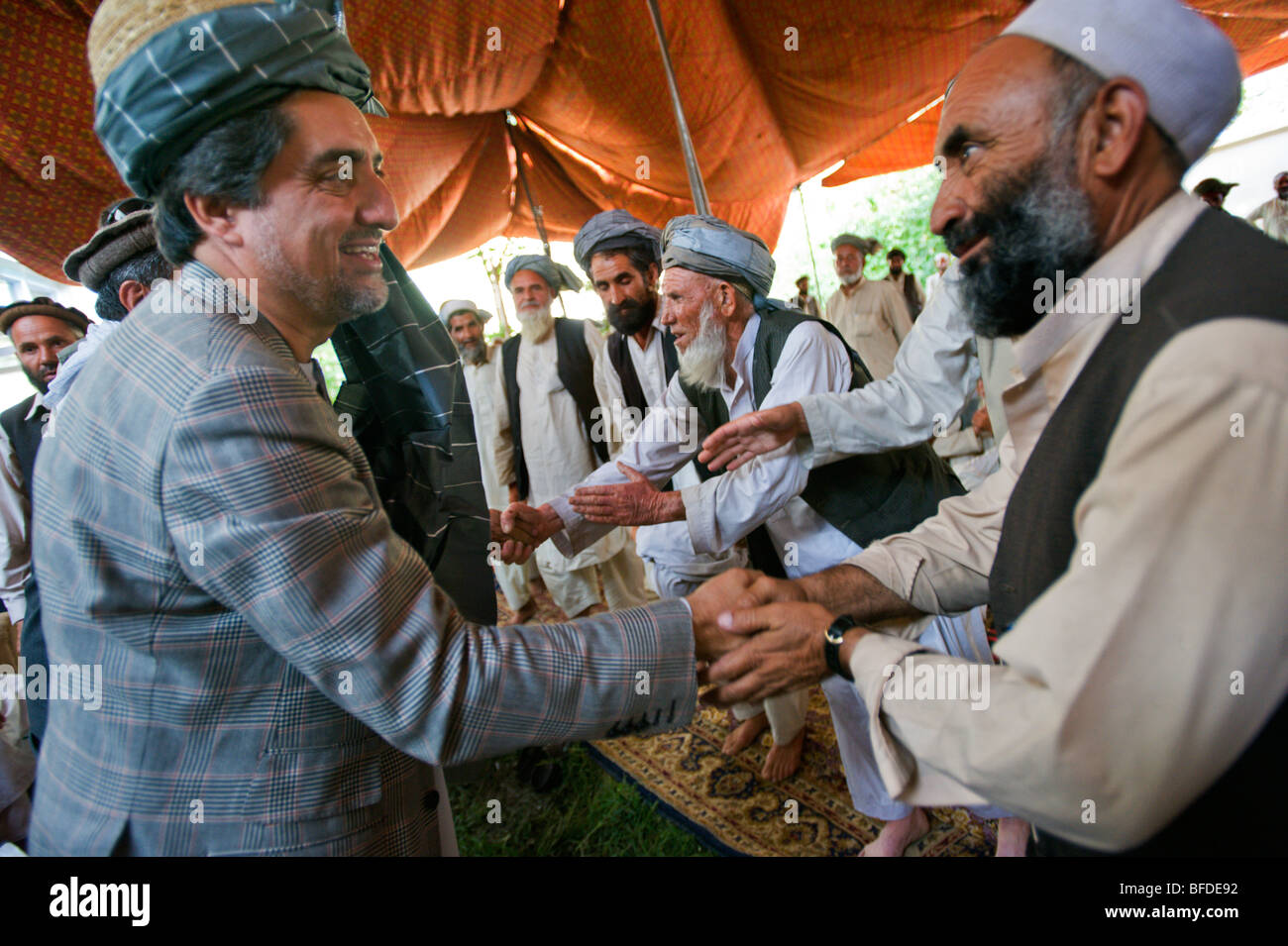 A presidential candidate of the Tajik tribe greets Pashtun leaders who ...