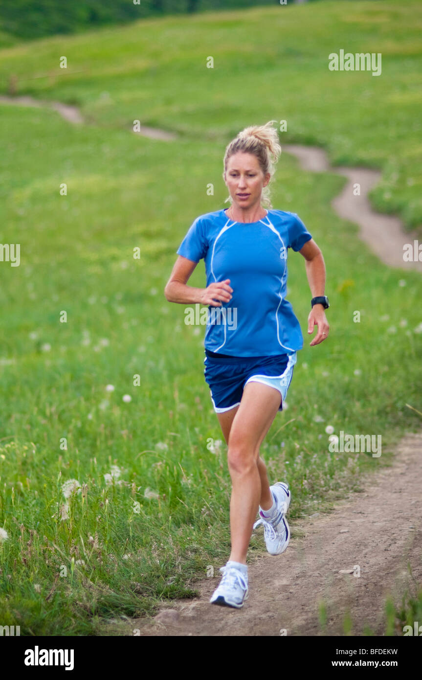A female marathon runner trains on a trail in Boulder, Colorado Stock ...