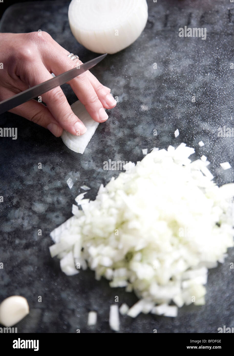Woman's hand chopping onions Stock Photo - Alamy