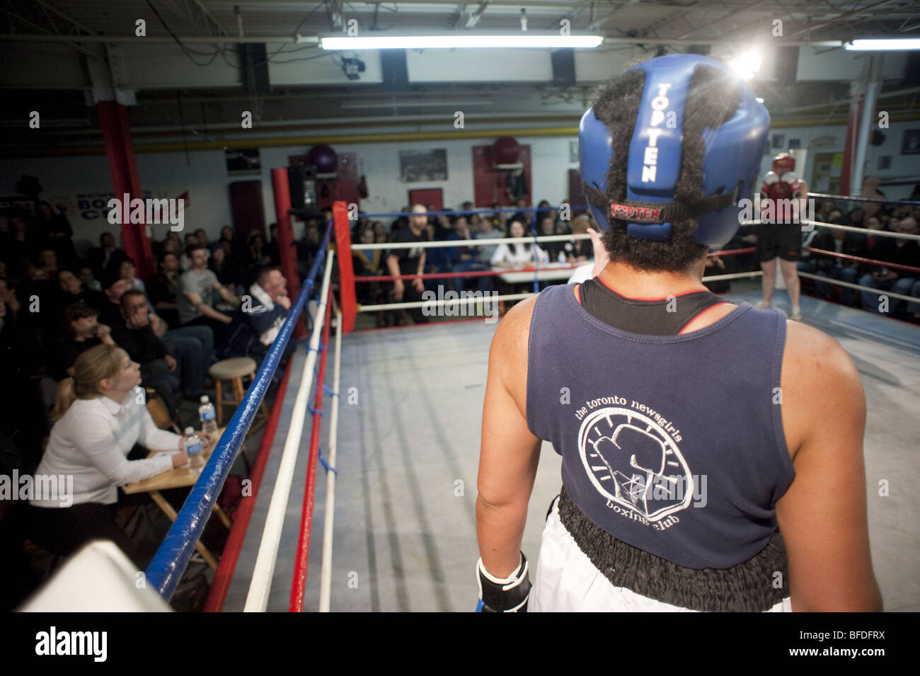 Two female boxers stare each other down during a break in the fight ...