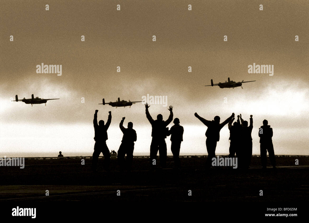 Soldiers cheer as bombers make a fly-by after just taking off from the ...