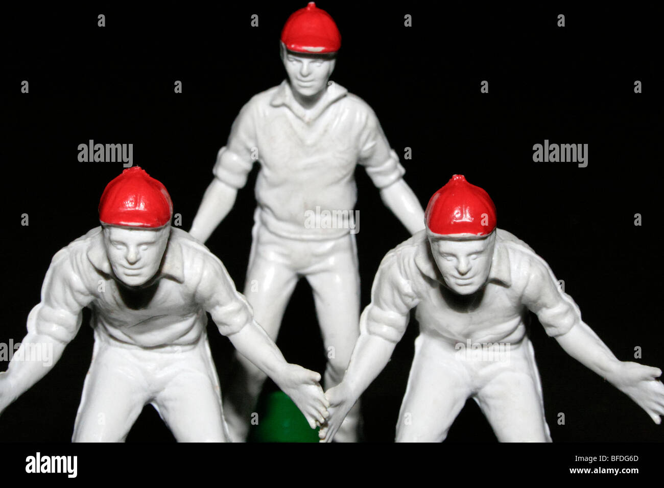 Toy men playing cricket on black background Stock Photo - Alamy