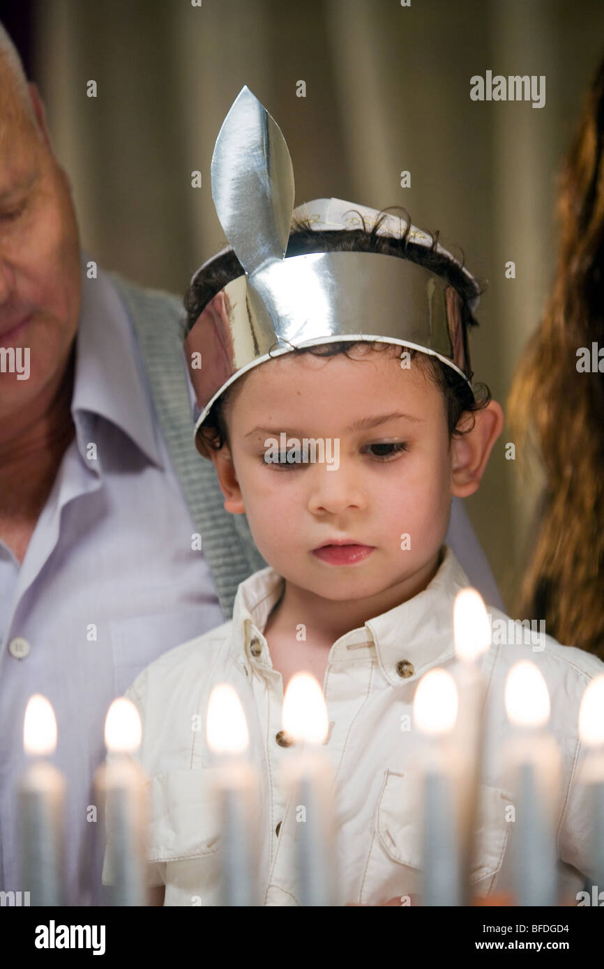 Boy lighting Hanukkah candles Stock Photo - Alamy