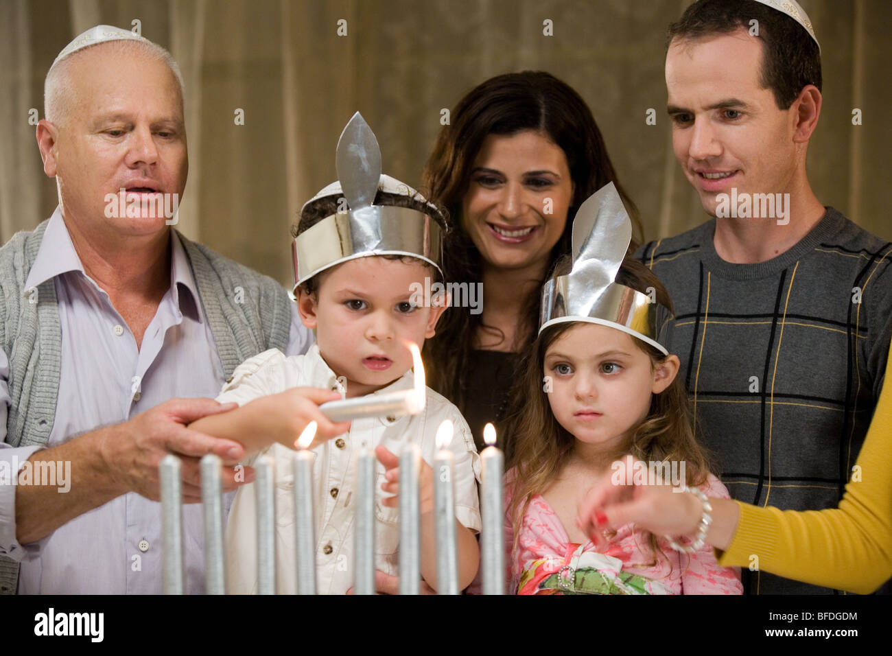 Family lighting Hanukkah candles Stock Photo - Alamy