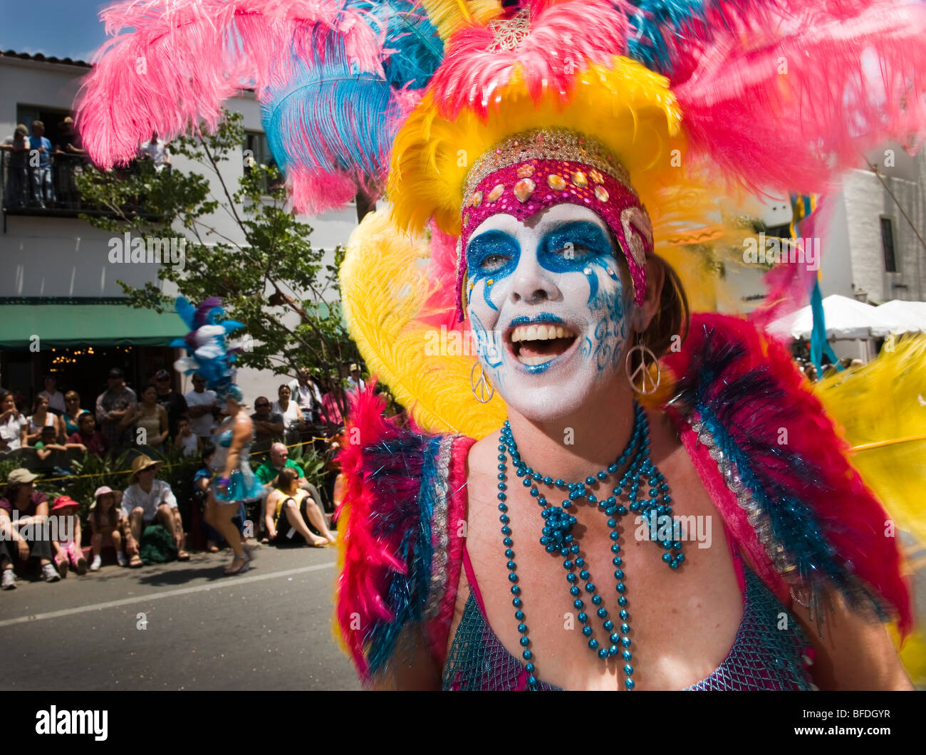 A woman's brightly painted face at a parade in Santa Barbara. The ...