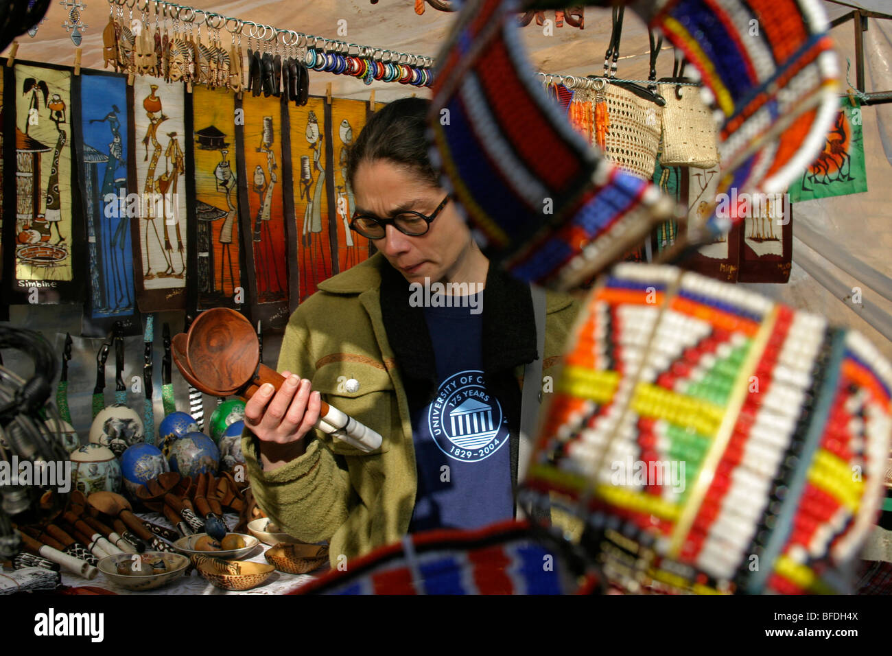A tourist browses through locally made curios while on a township tour ...
