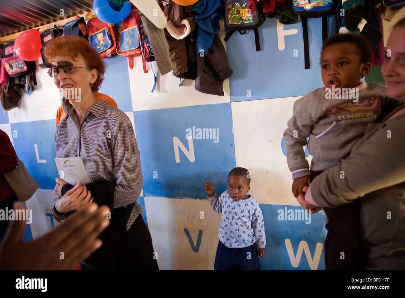 A tourist visits a local school while on a township tour in Kyamandi ...