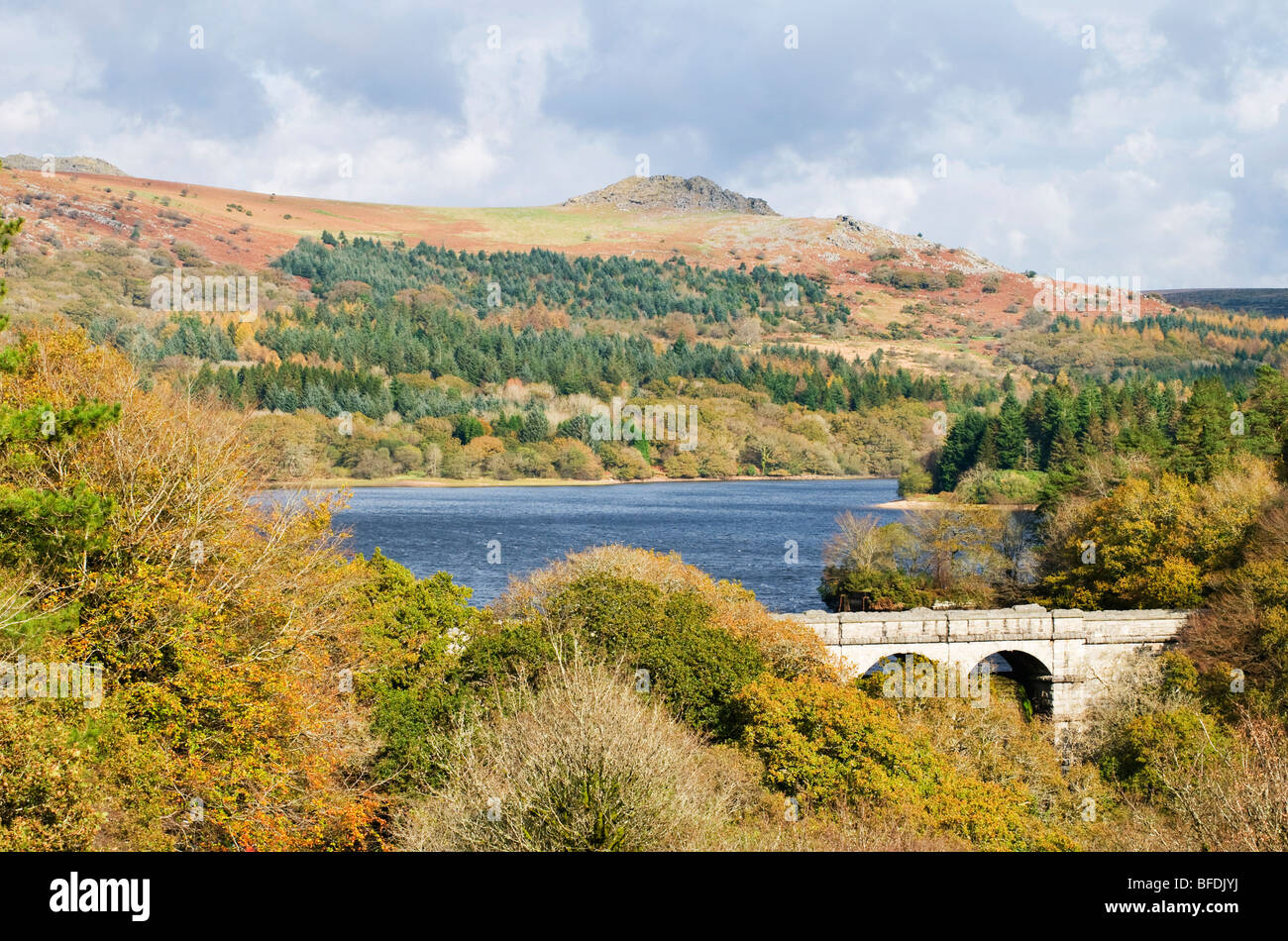 Burrator Reservoir dam and water with autumnal trees in foreground and ...