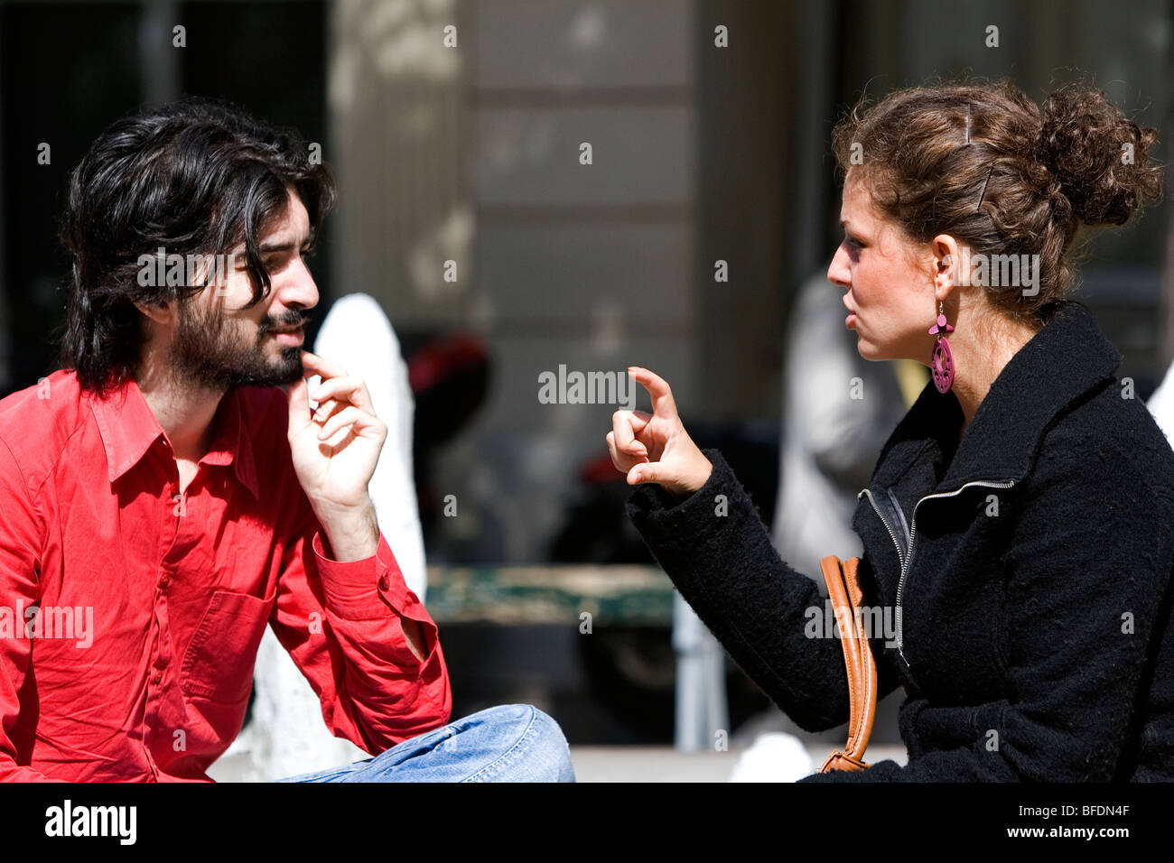 French man and woman have a conversation near the Sorbonne in Paris ...