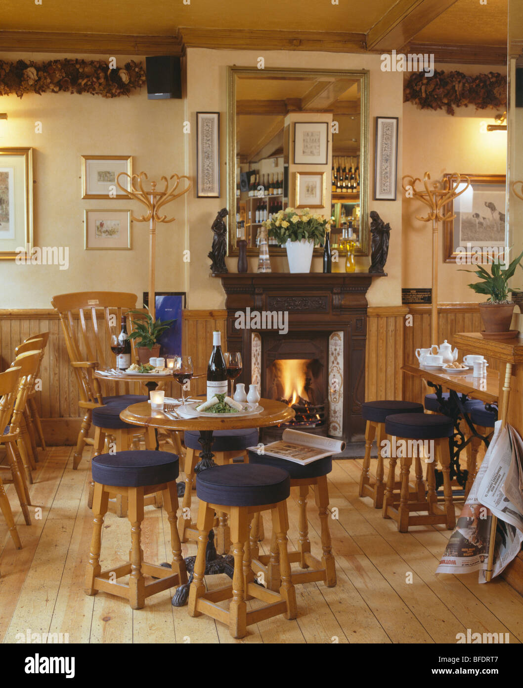 Pine tables and stools in traditional country restaurant with lighted ...