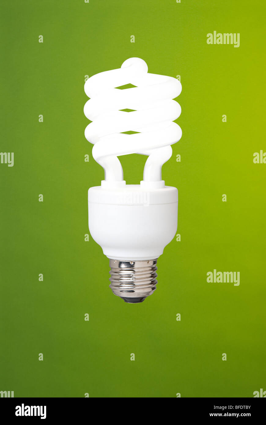 a compact fluorescent light bulb against a green background Stock Photo ...