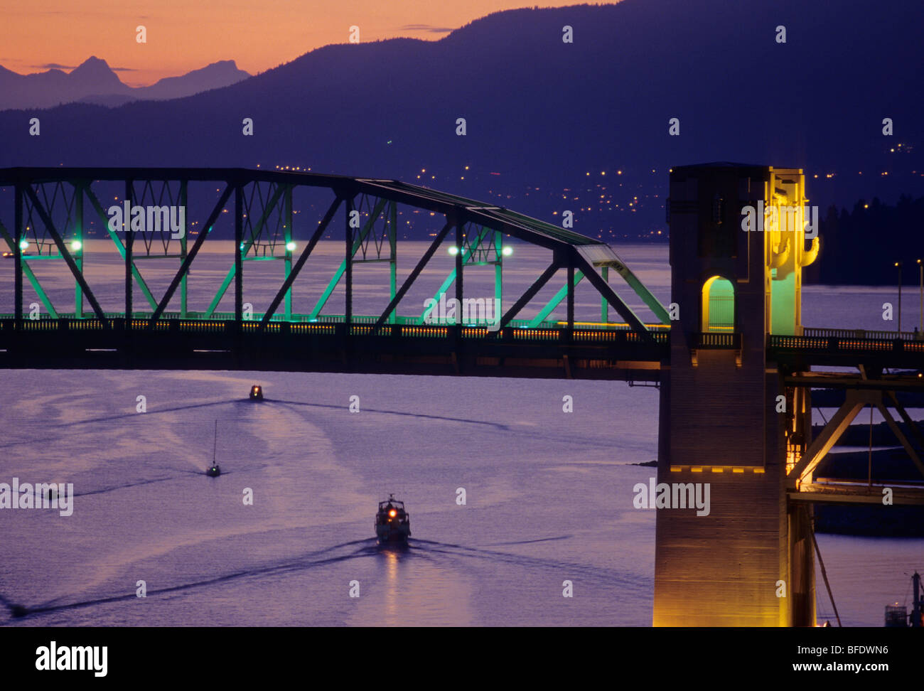 Boats travelling under the Burrard Bridge at night, Vancouver, British ...