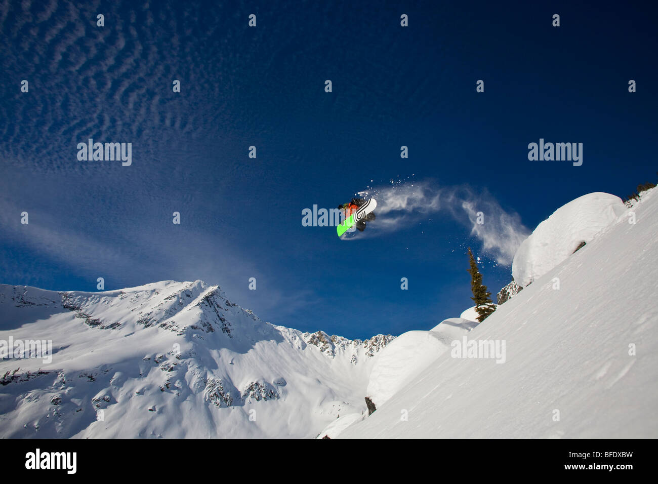 A snowboarder catching some air at Rogers Pass, Glacier National Park ...