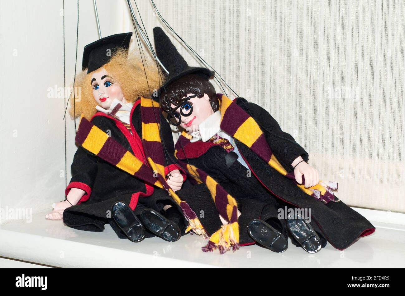 A pair of rejected and damaged puppets sitting on a window sill Stock ...