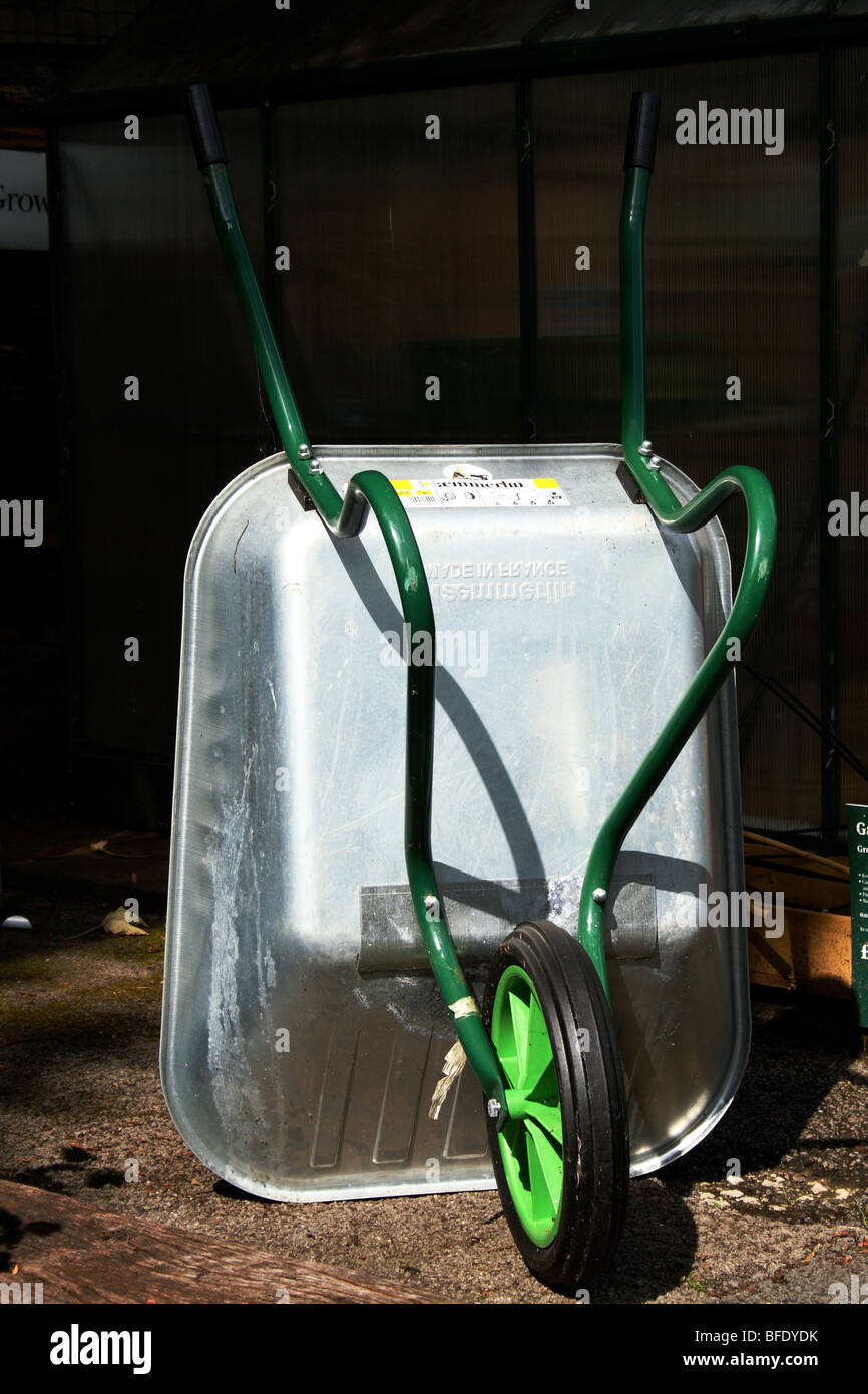 Green wheelbarrow used for Gardening or Horticulture a symbol of ...