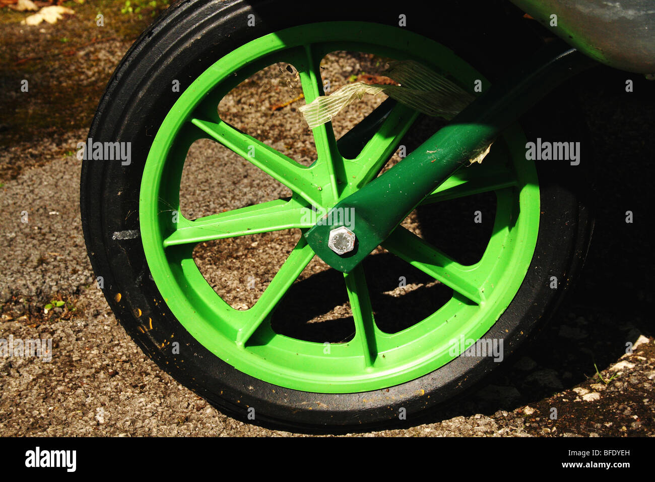Green wheelbarrow used for Gardening or Horticulture a symbol of ...