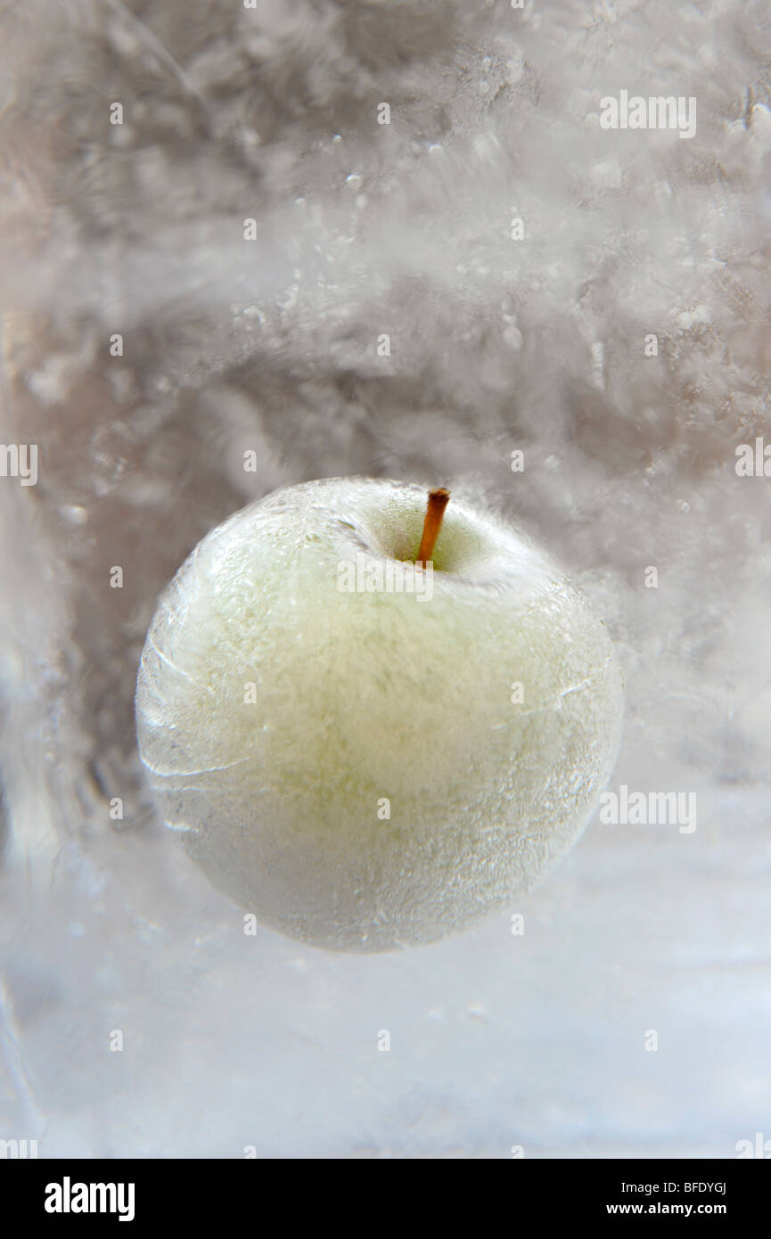 A frozen apple suspended in a block of ice Stock Photo - Alamy