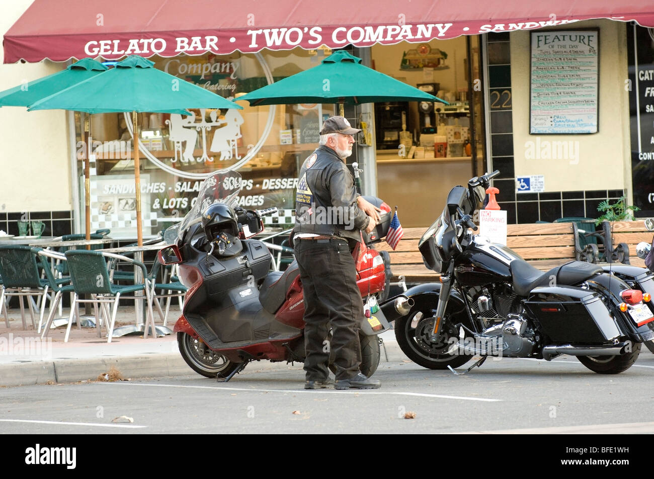 Man standing next to two motorcycles Stock Photo - Alamy