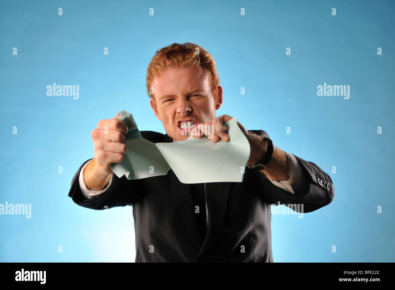 Angry man in suit tearing up papers Stock Photo - Alamy